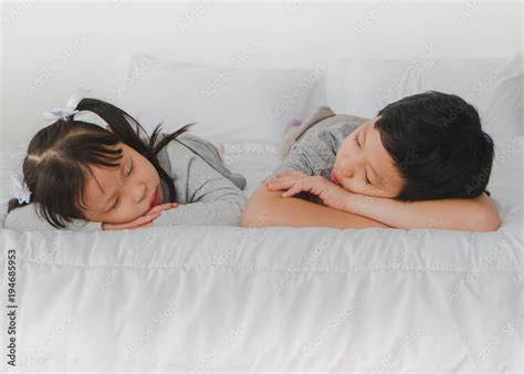 Asian Sister Sleeping With His Brother In White Bedroomconcept Of
