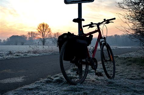 자전거 도로가 가는 아스팔트 강 의 가장자리 초기 여행자는 투어링 자전거에 기대어 둥근 창문 빨간 자전거 아이싱 아침 콘크리트 퍼골라 근처 스포츠 그라운드 야외 체육관 1