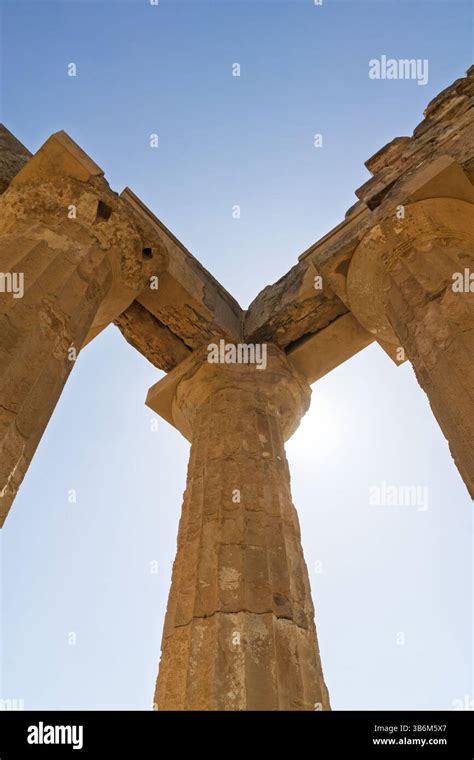 Sun Shining Behind Doric Order Columns Of An Ancient Greek Temple In