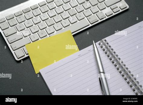 top view of office table with computer keyboard notepad pen and blank