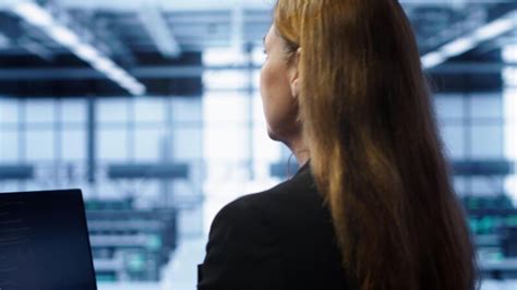 Technician Doing Checkup Inputting Data On Laptop Of Needed Server Hub