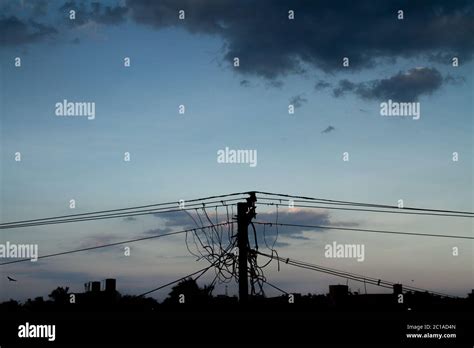 Clutter Electric Pole With Wires Background Dark Clouds With Sillhoutte