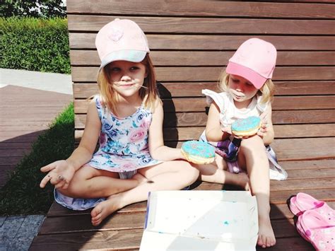 Premium Photo Portrait Of Smiling Girls Sitting On Table