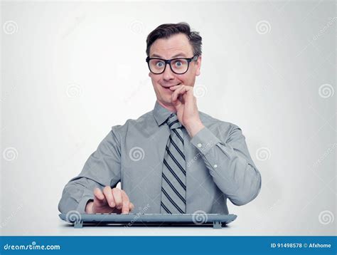 Man Programmer In Glasses With Keyboard In Front Of Computer Stock
