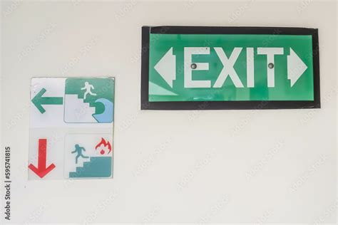 Fire And Flood Exit Sign In The Corridor Of The Building With Arrow Pointing To Safe Place
