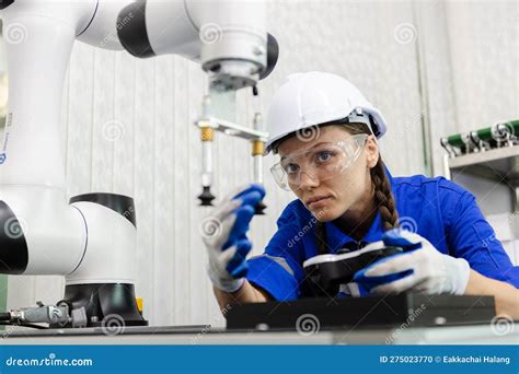 Female Technician Engineer Using Remote Control And Checking Automation