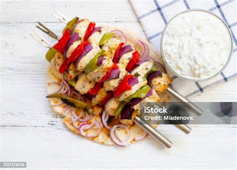 Tzatziki 소스와 피타 빵이 포함 된 그리스 전통 그릴 치킨 수블라키 밝은 배경입니다 평면도 0명에 대한 스톡 사진 및