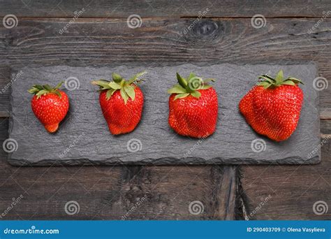 Strawberry On Wooden Background Minimal Food Concept Hardly From Largest To Smallest Four
