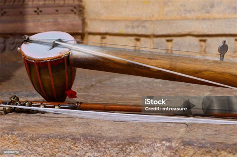 Closeup View Of Ravanahatha Lying Outdoors On Top Of Wall Bowed Stringed Folk Instrument Round