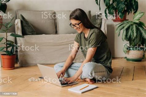 바닥에 앉아있는 웃는 여학생은 원격 학습과 작업을 위해 노트북을 사용합니다 20 24세에 대한 스톡 사진 및 기타 이미지