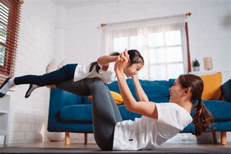 Mother And Babe Exercising Together Happily At Home For Flexibility Build Muscle Strength