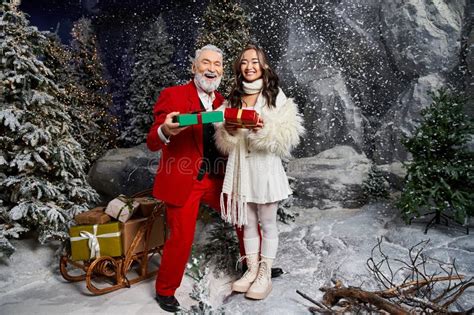 A Cheerful Duo Holds Brightly Wrapped Stock Image Image Of Celebration Snow