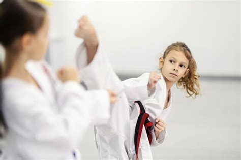 Premium Photo A Taekwondo Girl Is Kicking During Combat In Martial