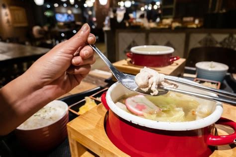 Premium Photo Woman Eating Hot Pot