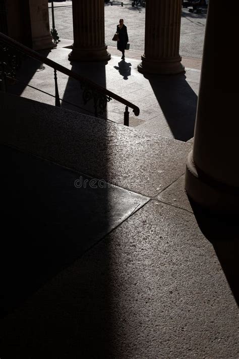 Vertical Shot Of Sunlight Filtering Through Columns Of A Building Stock