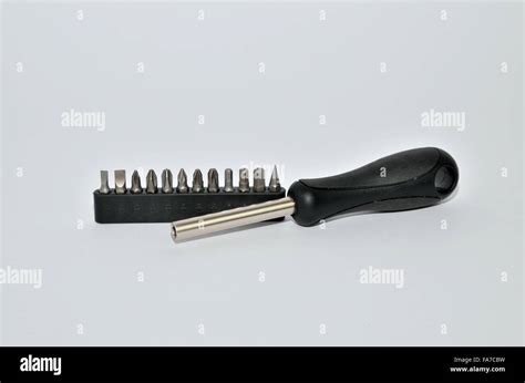 Screwdriver With Twelve Interchangeable Bits Of Different Shapes Stock Photo Alamy