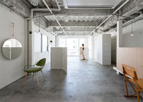 Hair Salon With An Exposed Ceiling And Twisting Lights By Sides Core
