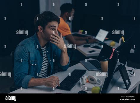 Selective Focus Of Surprised Programmer Looking At Monitor While
