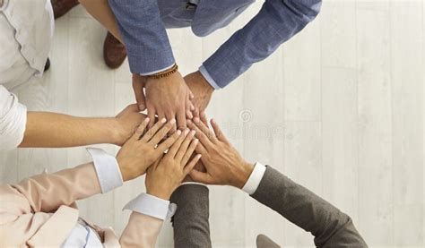 Business Colleagues Folding Their Hands On Each Other Which Symbolizes