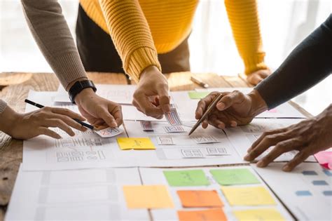 Premium Photo Ux Developer And Ui Designer Brainstorming About Mobile App Interface Wireframe
