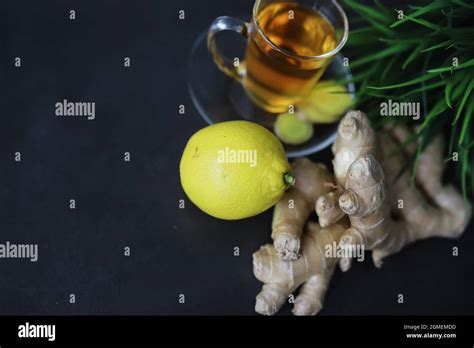 Ginger Root Whole And Sliced Ginger Tea With Lemon On The Dark