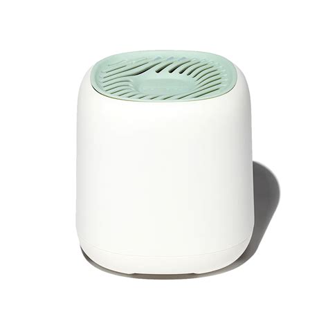 An Air Freshener Sitting On Top Of A White Surface Next To A Shadow