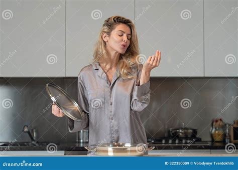 Blond Beautiful Girl Cooking In Kitchen Doing Breakfast With Healthy
