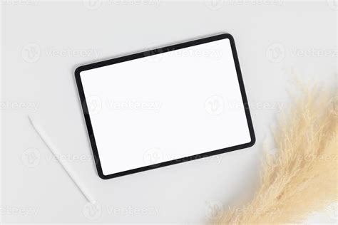 white tablet and stylus with copy space blank screen light background