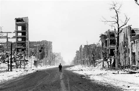 A Chechen Elder Stands In The Center Of The Devastated Chechen Capital