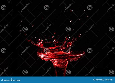 Close Up A Drop Of Wine In The Form Of A Crown Is Split On The Glass