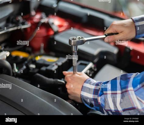 Female Auto Mechanic Unscrewing A Nut To Replace A Car Spark Plug Stock Photo Alamy