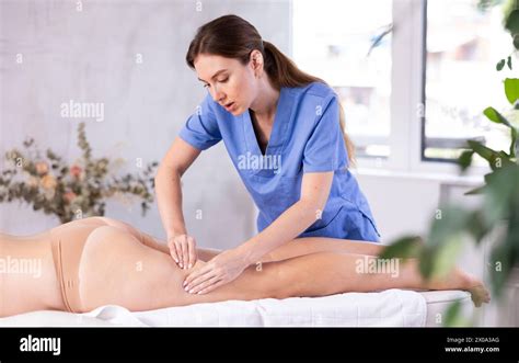 Professional Female Massage Therapist Doing Thigh And Buttocks Massage