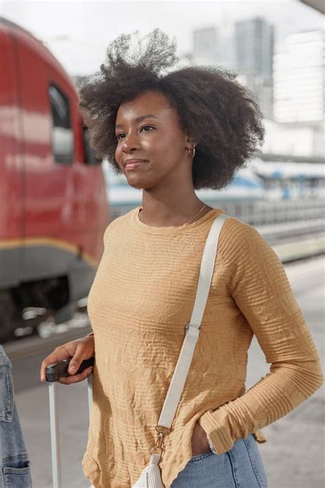 Couple Having Fun Using Smartphone While Waiting For A Train At Railway Station Stock Image