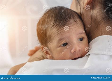 Mother Holding Her Infant Baby Boy On Her Shoulder Stock Photo Image