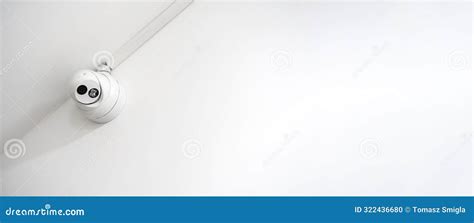 One Single Simple Security Camera On A White Wall Background Wide Shot