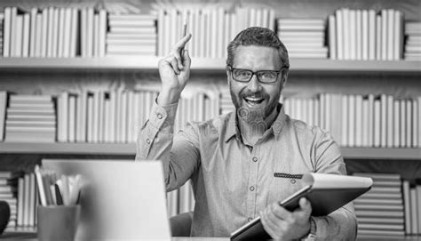 Teacher In Classroom School Tutor With Book In Classroom Man On