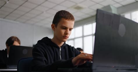 Teenager Working With Laptop In Classroom Learning Of Coding And