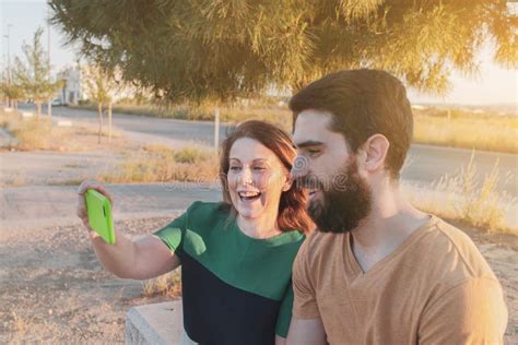 Two People Mother And Son In Law Smiling And Talking By Video Call With
