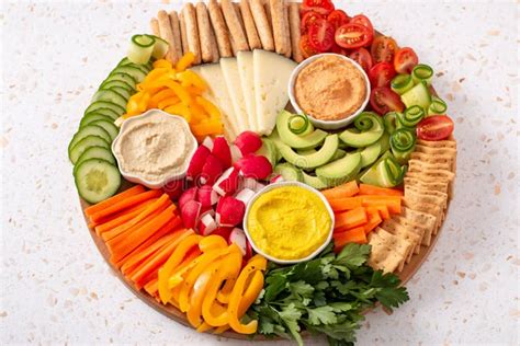 Colorful Vegan Charcuterie Board With Raw Vegetables And Whole Wheat