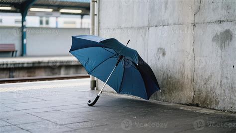 A Lonely Umbrella Stands Open Against A Textured Concrete Wall At A