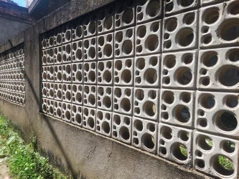 Cement Ventilation Wall With Artistic Circular Holes Creating Geometric