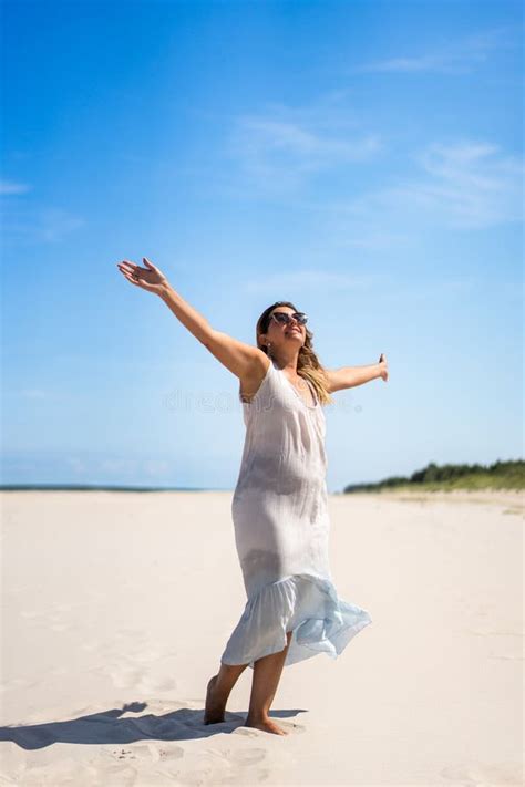 Middle Aged Beautiful Woman With Long Hair In Light Dress And