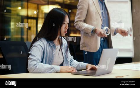 Man Using Wireless Controllers Examining Blueprint In Virtual Reality Asian Female Engineer