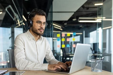 Serious Thinking Programmer Coding New Software Man In Headphones Working With Laptop Inside
