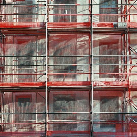 Scaffolding With Safety Netting For Construction Site Protection Premium Ai Generated Image
