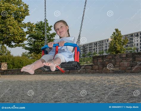 Barefoot Girl Rides A Swing On A Playground Swing Stock Image Image