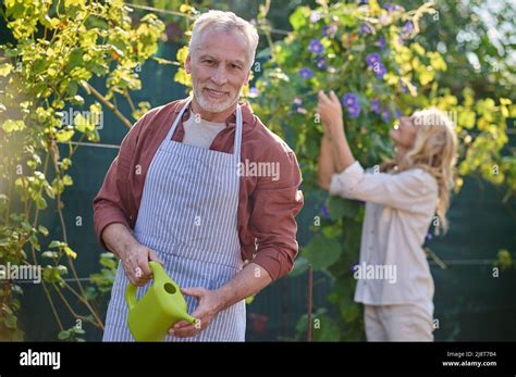 Man Looking At Camera And Woman Behind Stock Photo Alamy