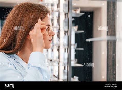 Woman Is With Glasses In The Store Choosing Right Eyewear For