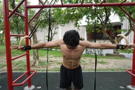 Premium Photo A Man Is Doing A Push Up Bar On A Swing
