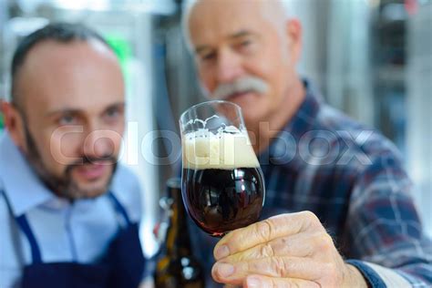 Workers Adoring The Frothy Beer Stock Image Colourbox